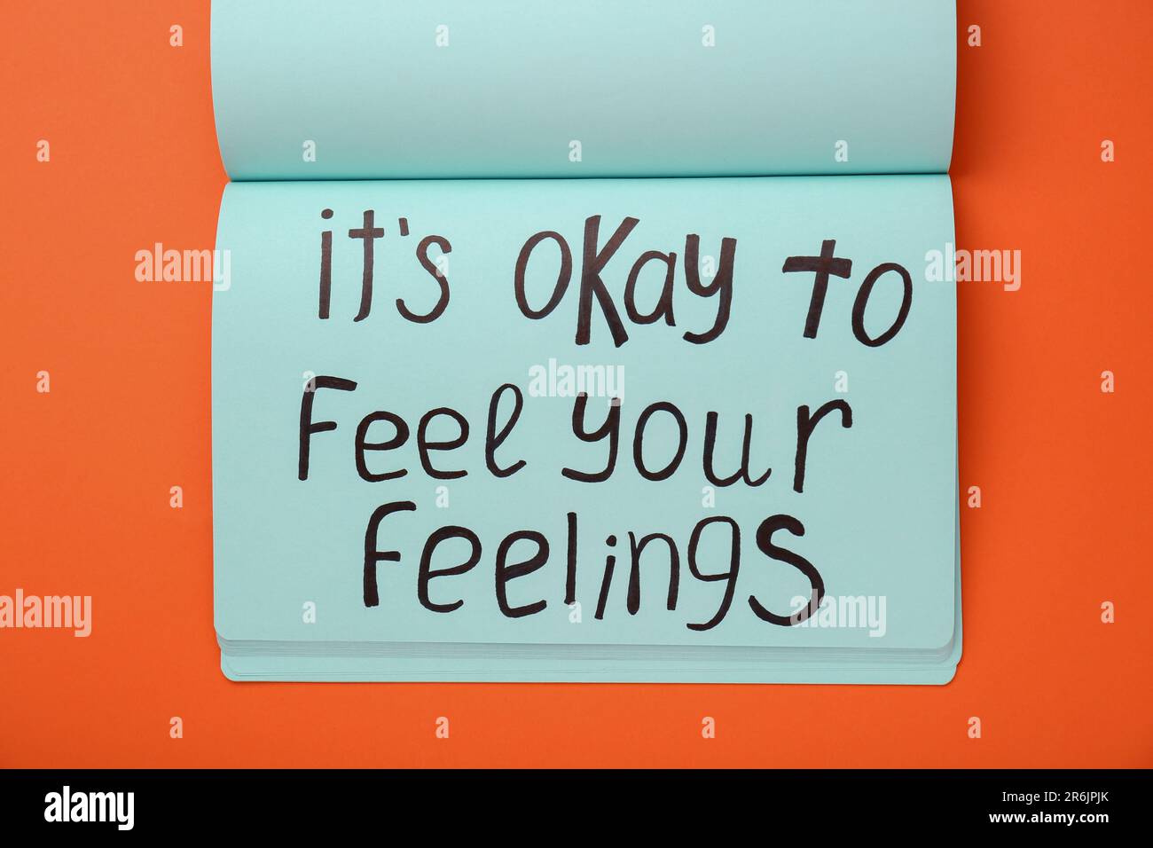Notebook with phrase It`s Okay To Feel Your Feelings on orange ...