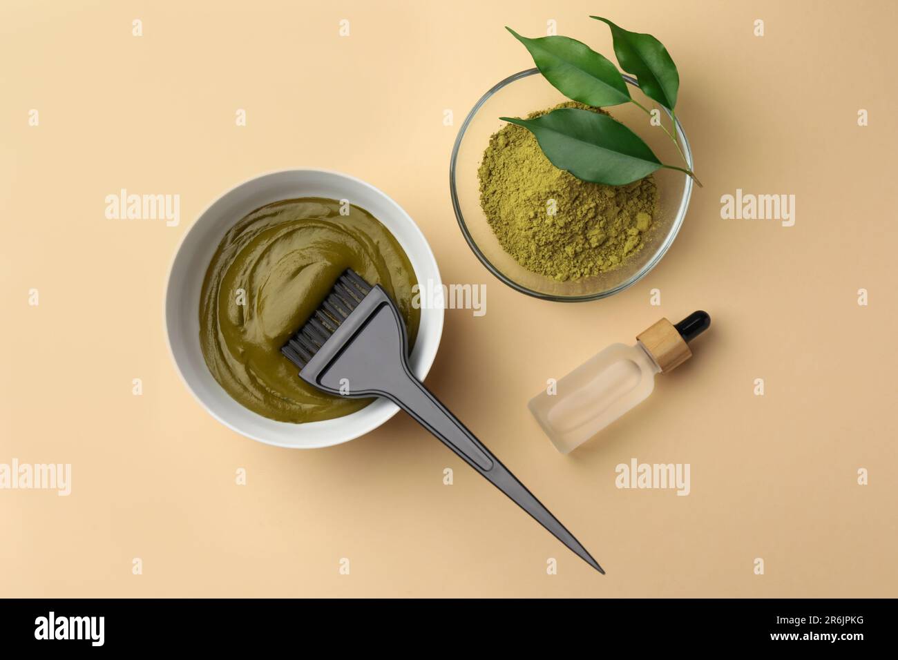 Henna powder and cream, bottle of liquid on beige background, flat lay ...