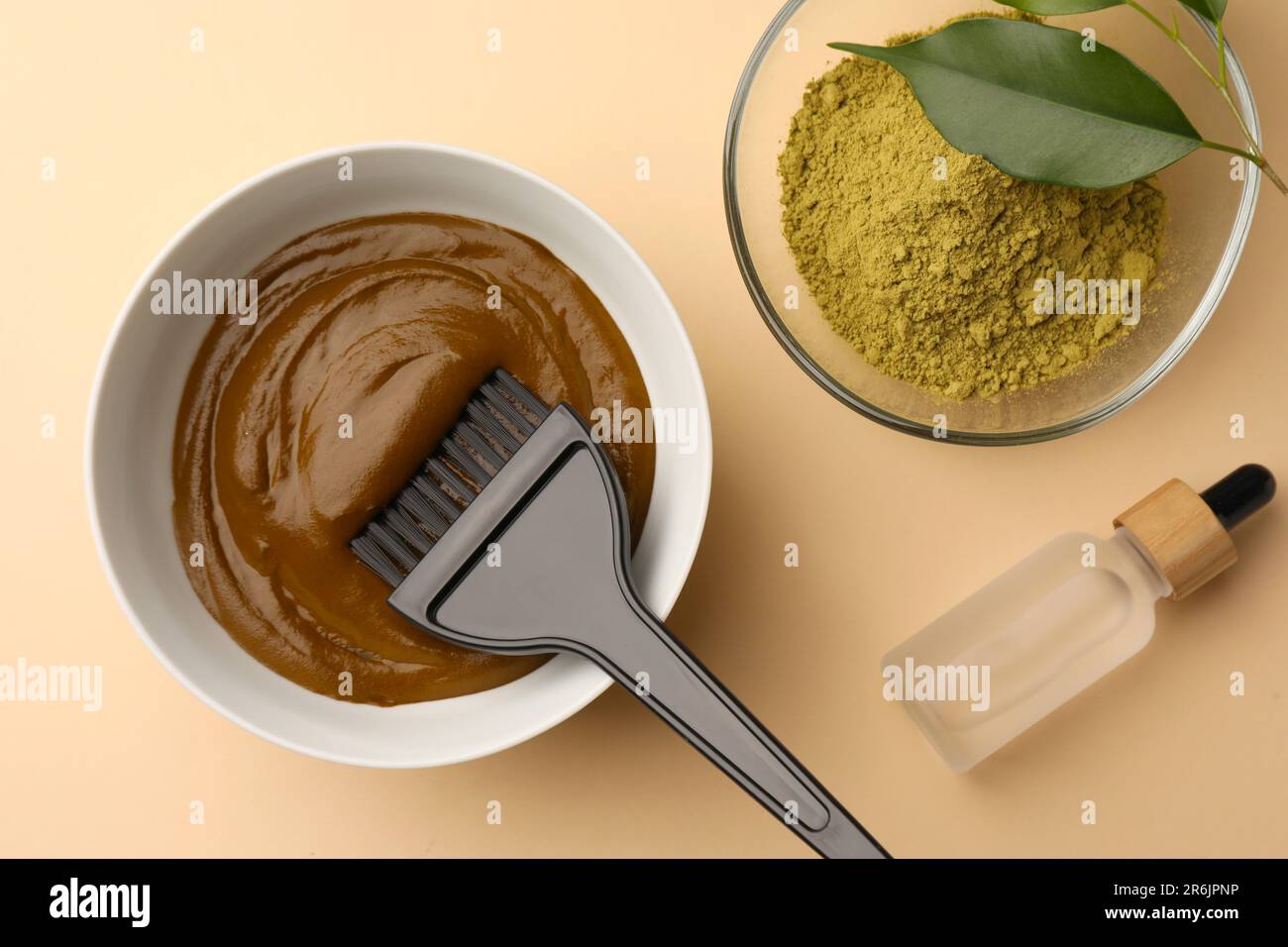Henna powder and cream, bottle of liquid on beige background, flat lay ...
