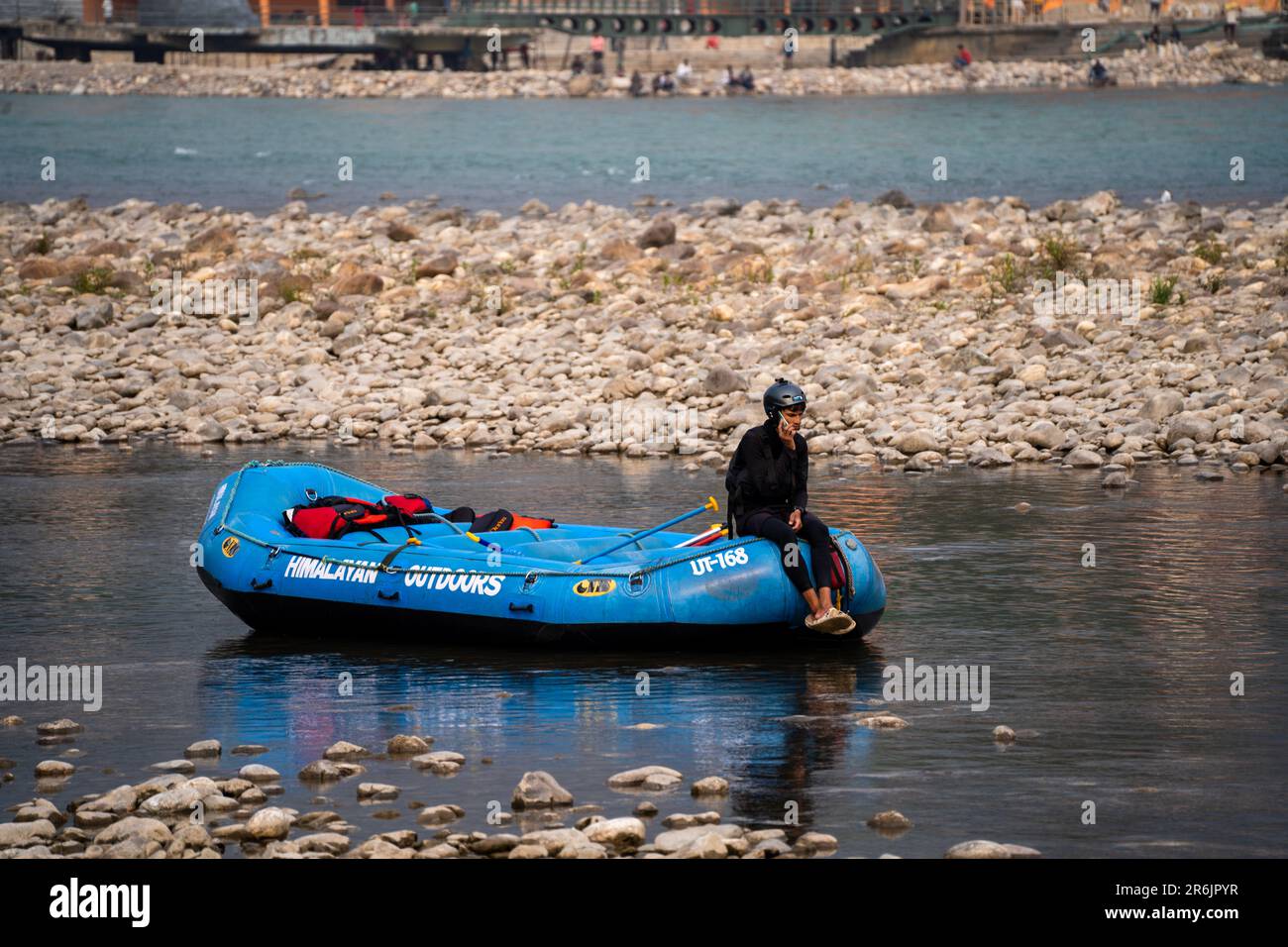 man in black enjoying solo ride on inflatable white water raft while ...
