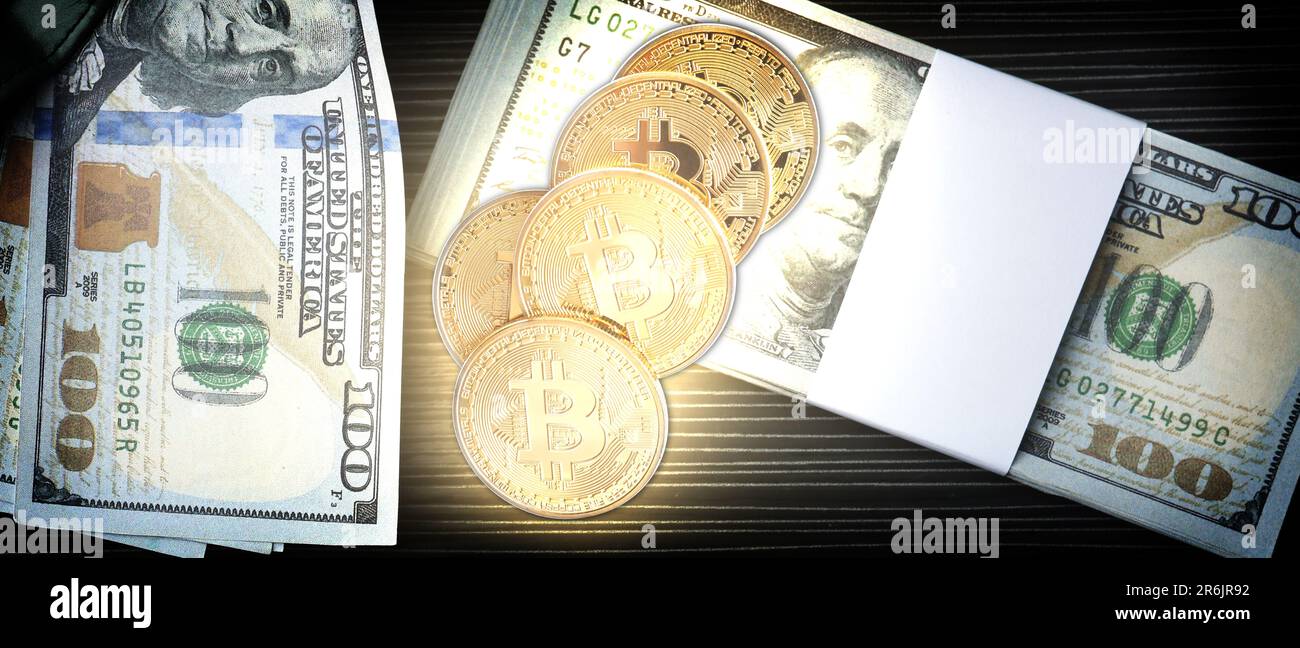 Bitcoins and dollar banknotes on black wooden background, flat lay ...
