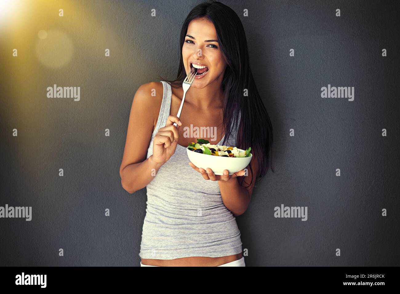 Woman is eating a salad, healthy food and diet, portrait and vegetables ...