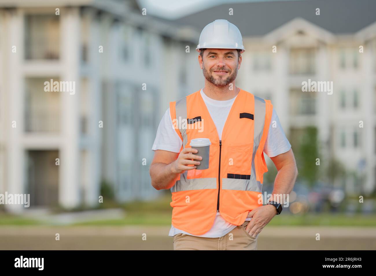 Engineer drinking take away coffee on break. Builder on site ...
