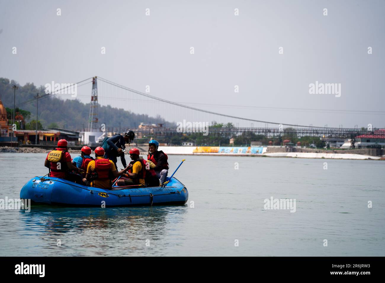 family friends in white water raft in front of temples ghats and the ...