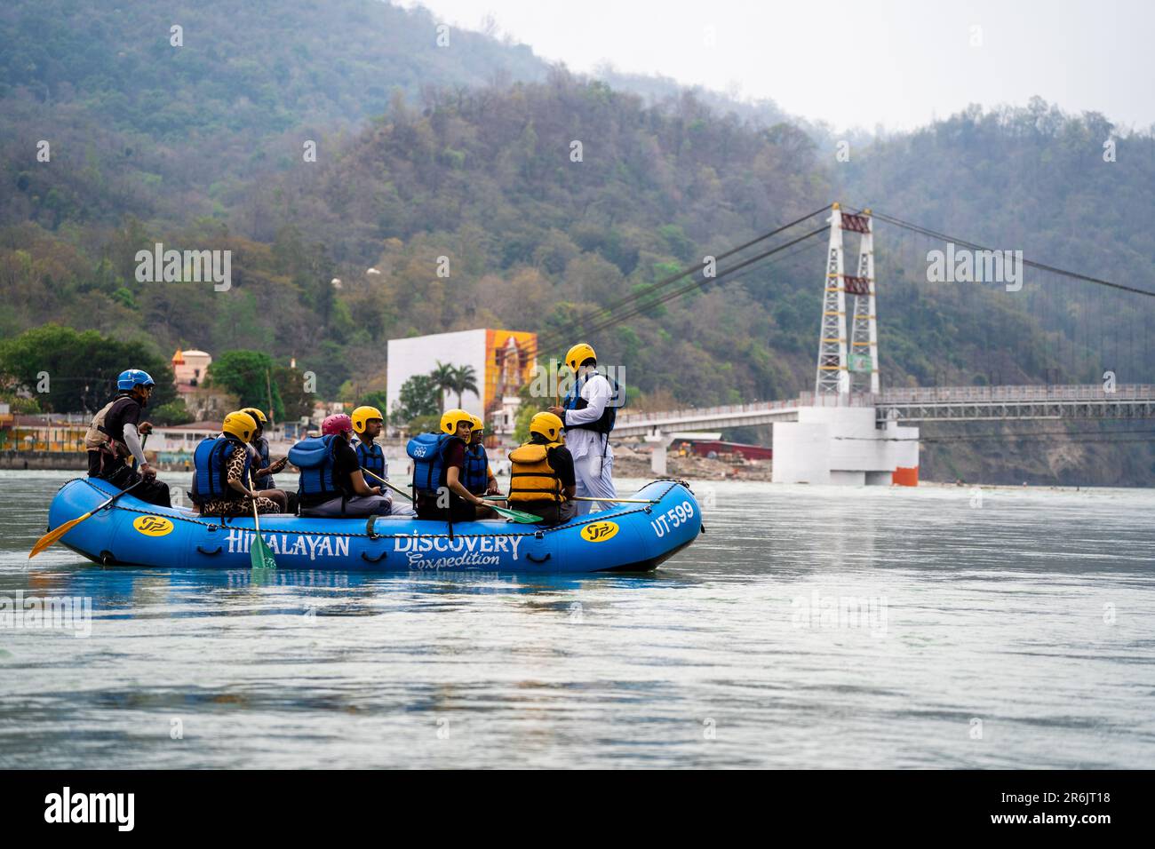 family friends in white water raft in front of temples ghats and the ...