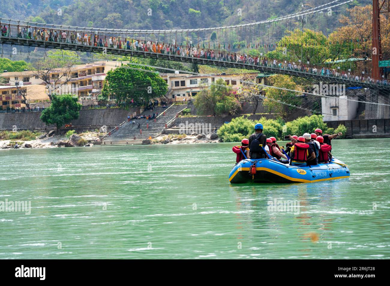 family friends in white water raft in front of temples ghats and the ...