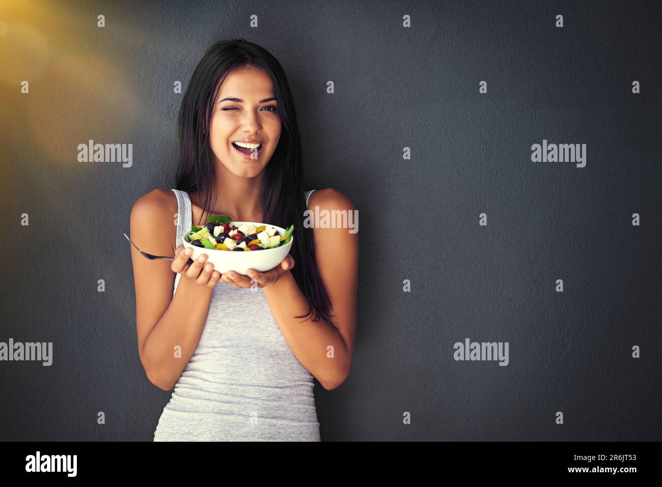 Woman wink with salad, healthy food and nutrition, portrait and ...