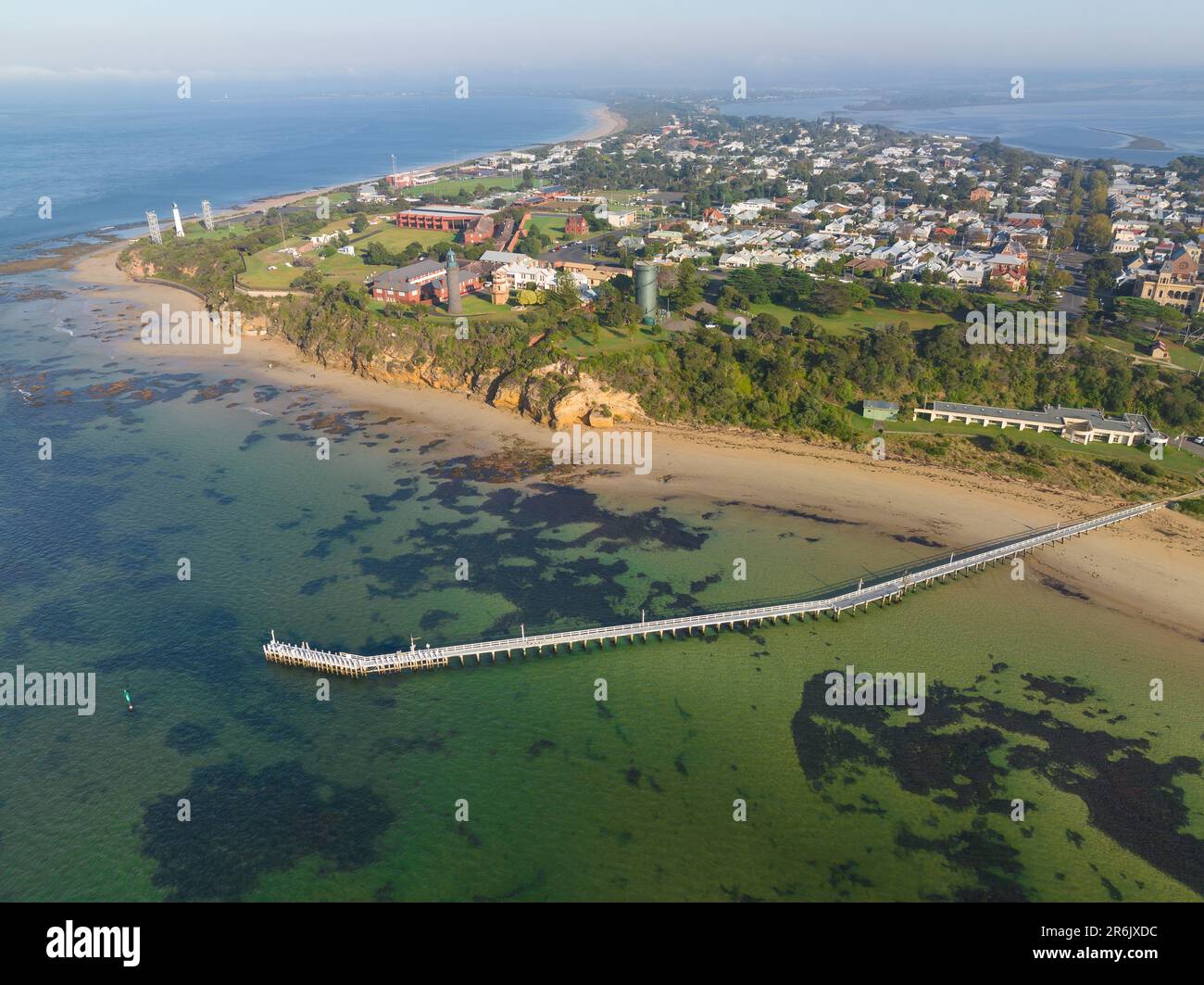 Aerial view of a long jetty in front of a coastal town on a Peninsula ...
