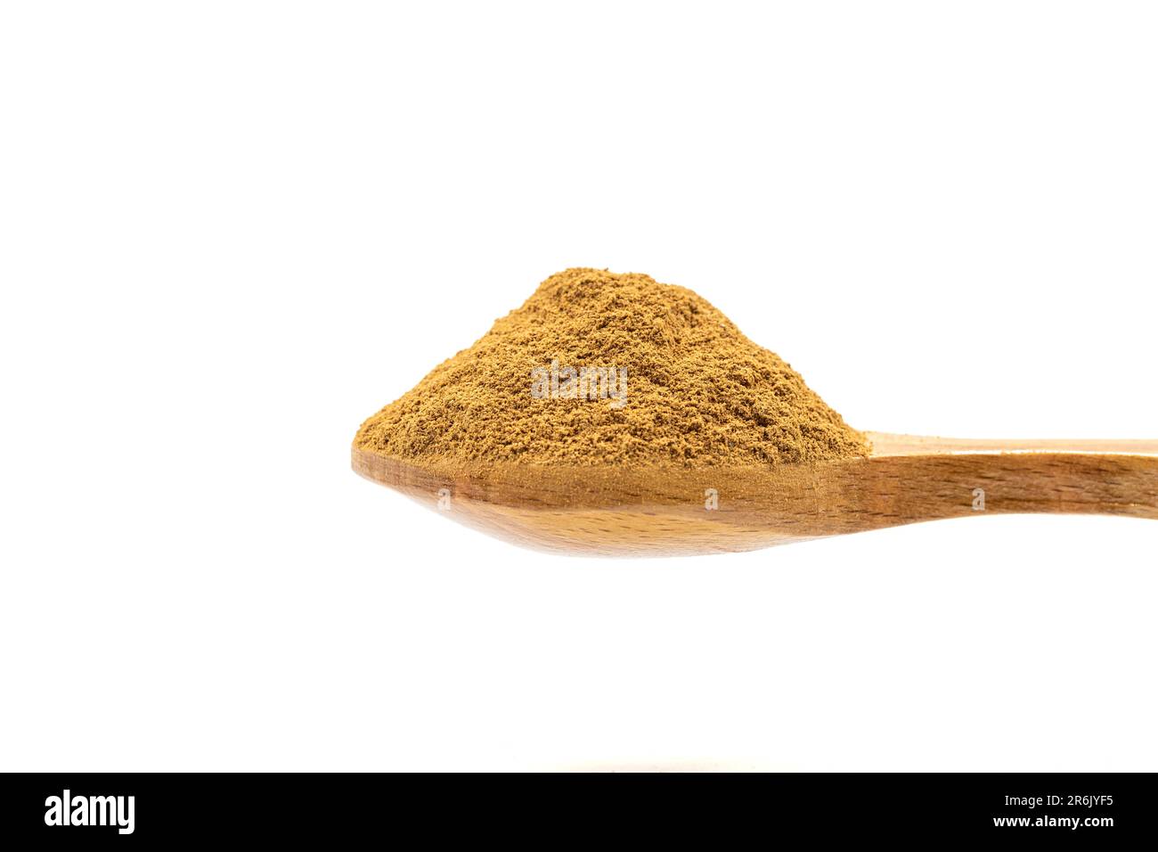 Powdered cinnamon on wooden spoon. Pile of cinnamon powder isolated on ...