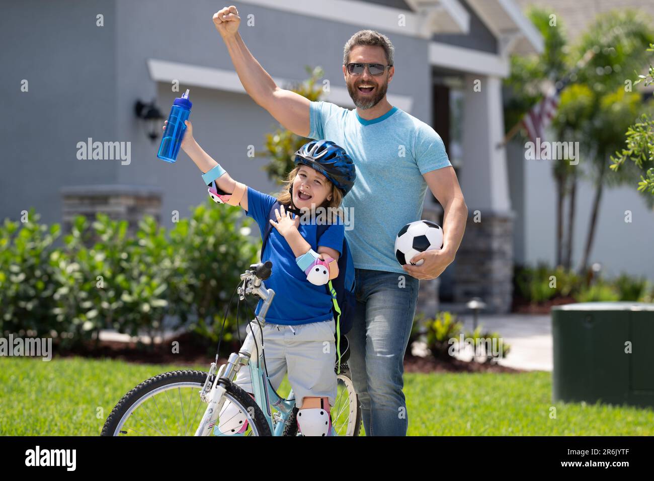 Sporty family. Excited father and son with winning gesture. Father and ...