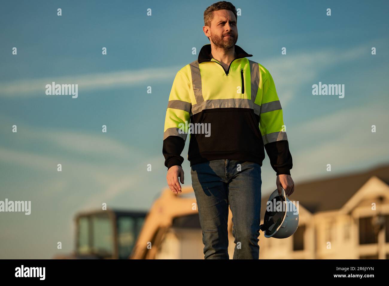 Worker in helmet on site construction. Man excavator bulldozer worker ...