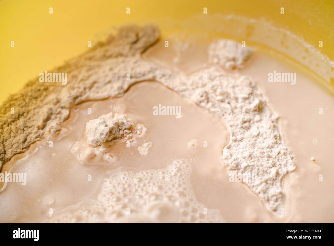 Mixing flour, dry yeast and water. Cooking dough for bread or pizza ...