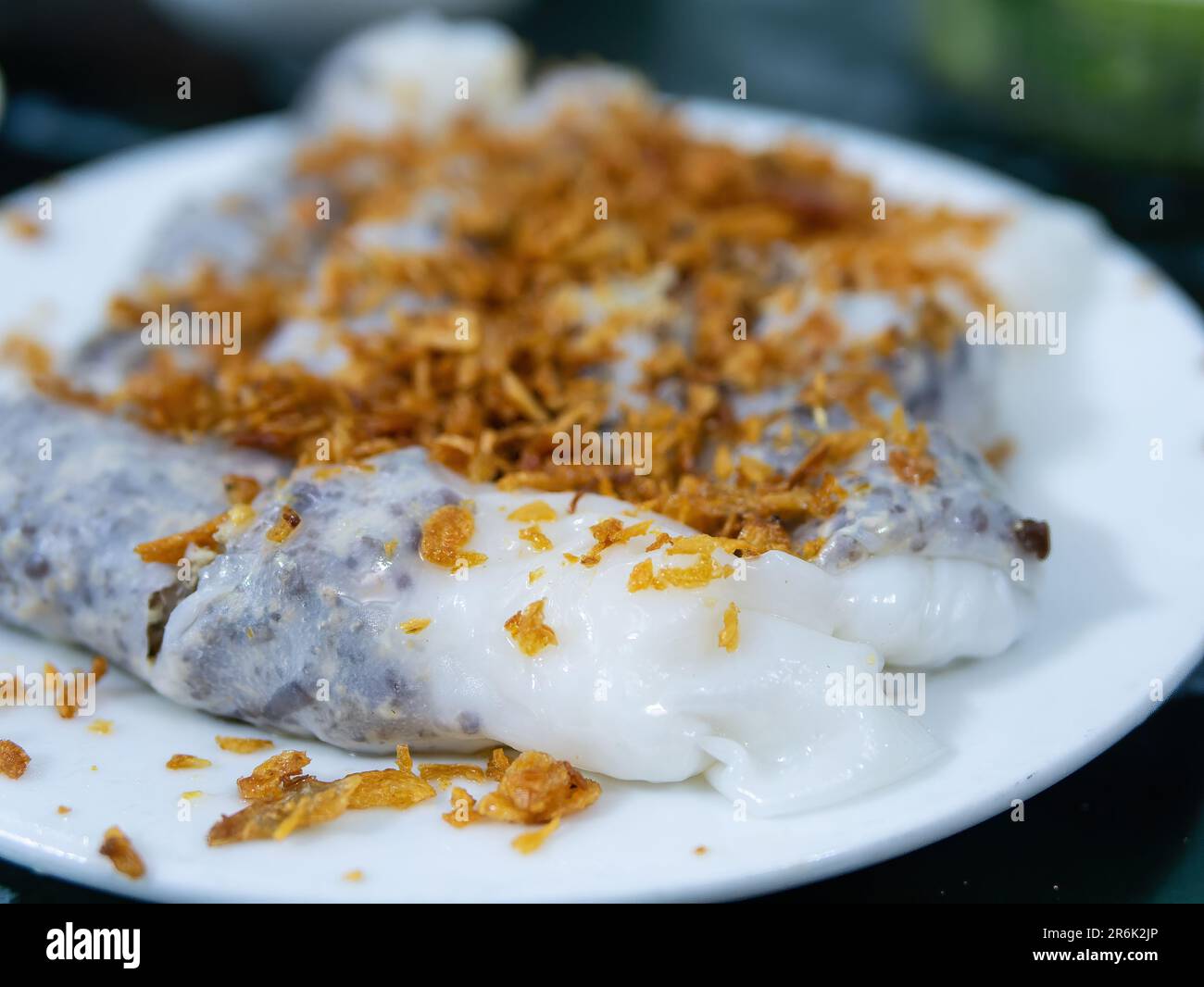 Banh cuon, rice sheet rolls with minced pork, garnished with hanh phi ...