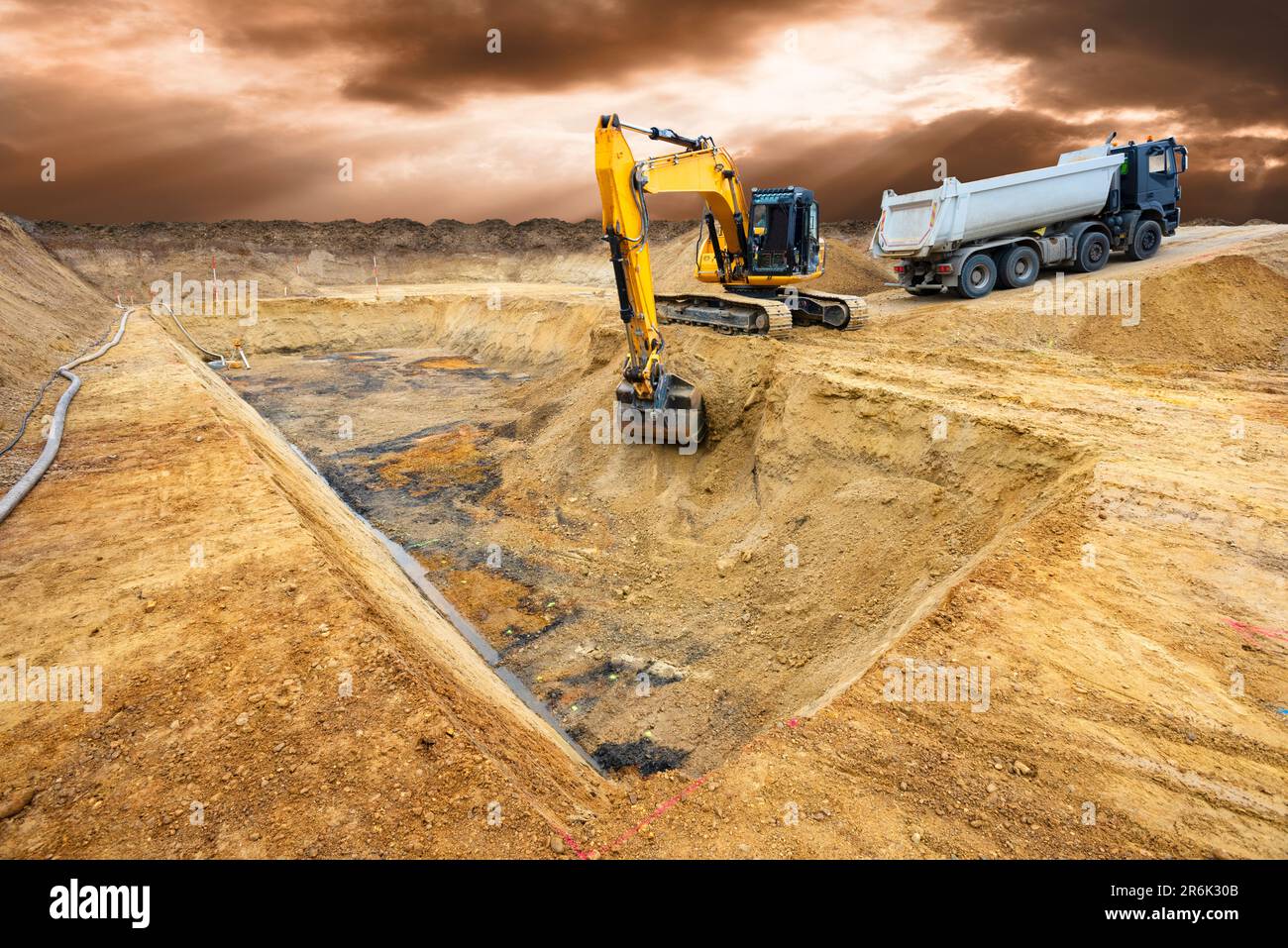 excavator is working and digging at construction site Stock Photo - Alamy