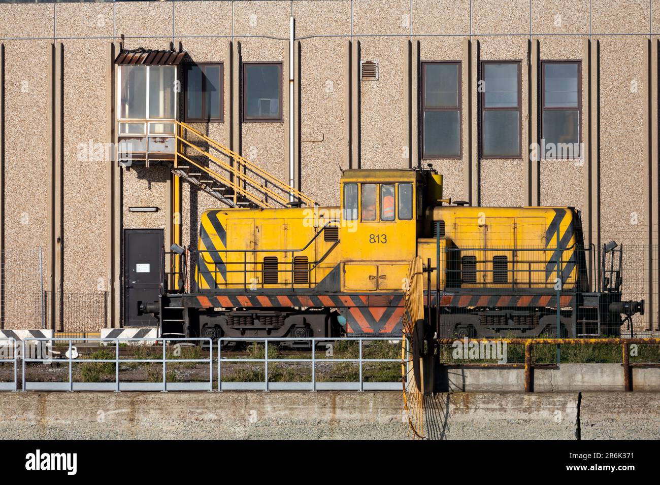 Locomotive of industrial train with a building on the background Stock ...