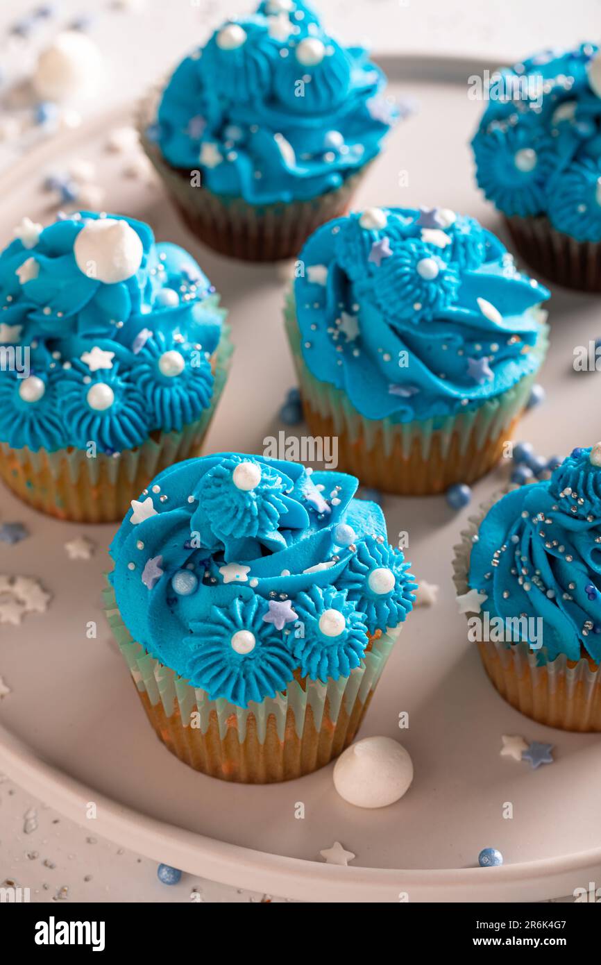 Delicious and homemade cupcakes with blue whipped cream. Perfect blue ...