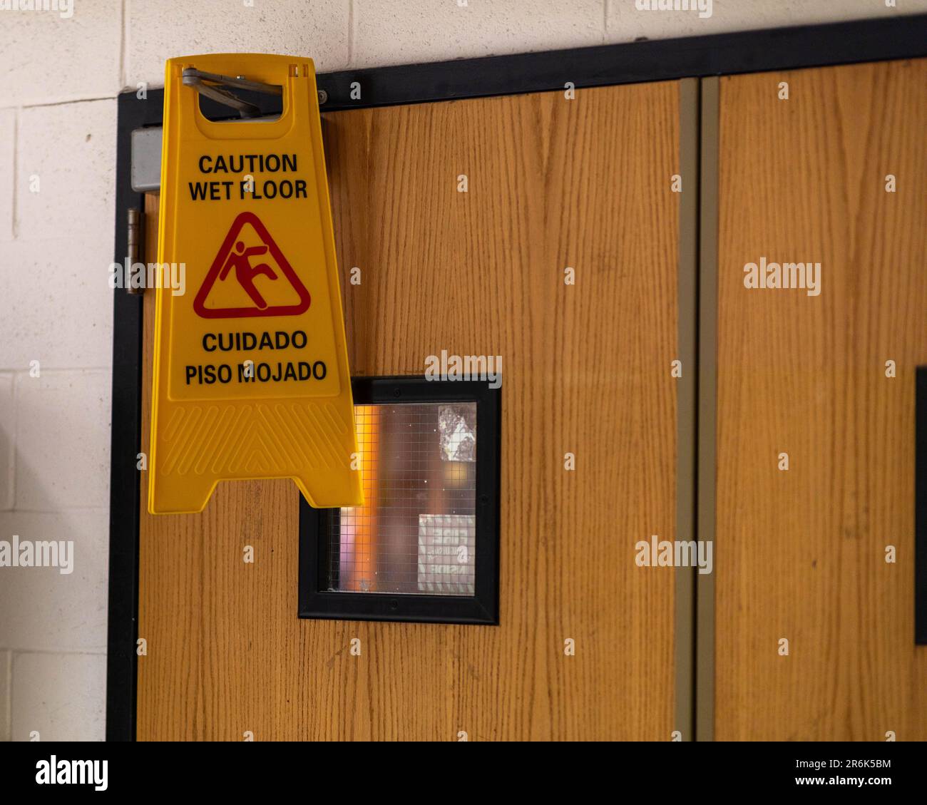 safety floor sign hanging on a door for some reason Stock Photo - Alamy