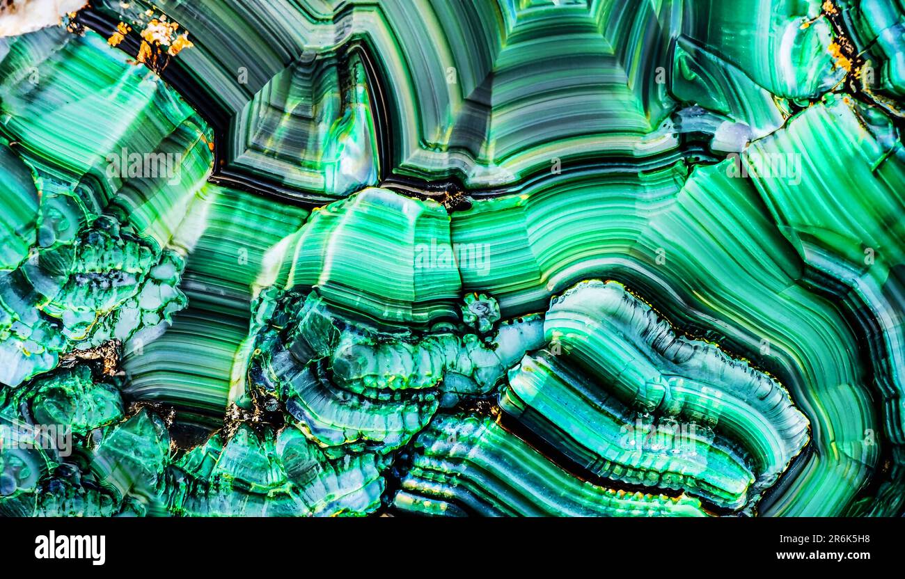 Unusual patterns of the polished malachite gemstone. Abstract green ...