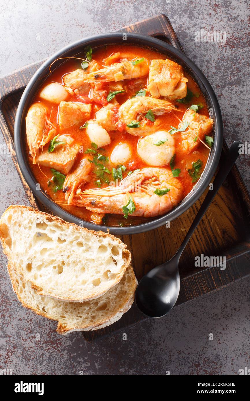 Mediterranean thick stew of seafood and fish with tomatoes close-up in ...