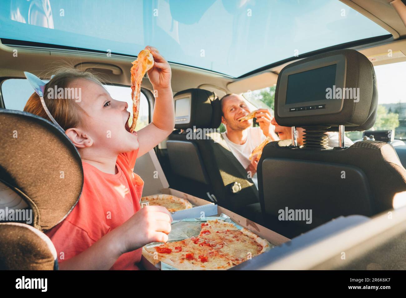 Little girl with open mouth portrait eating Italian pizza sitting in ...