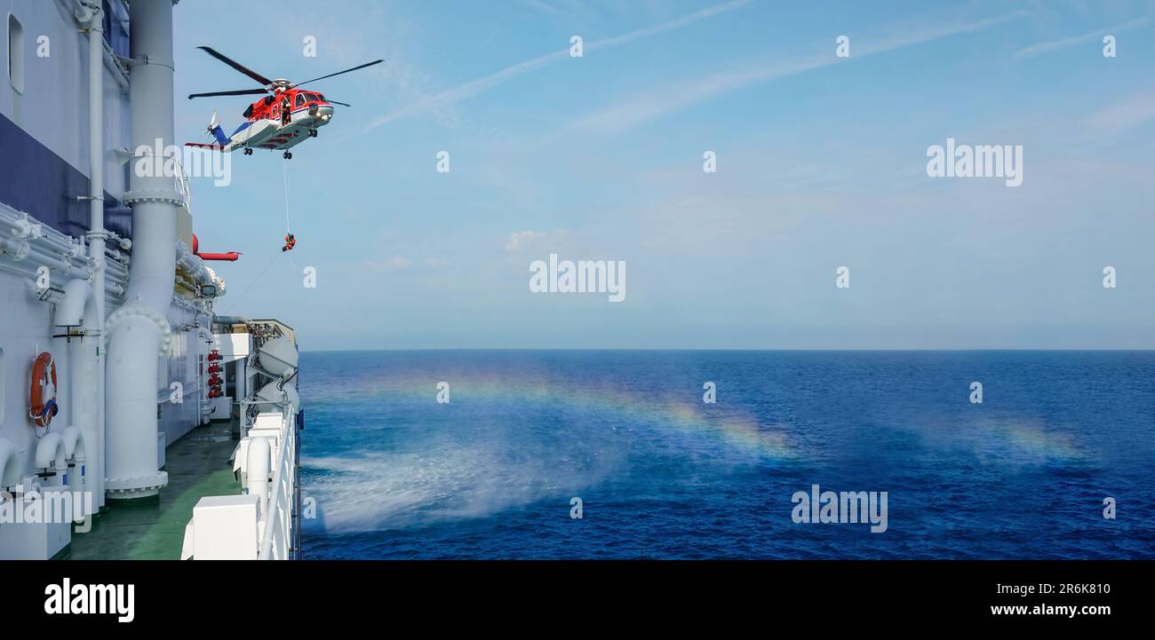 Air-sea rescue operations. Red rescue helicopter and Oil Tanker Ship ...