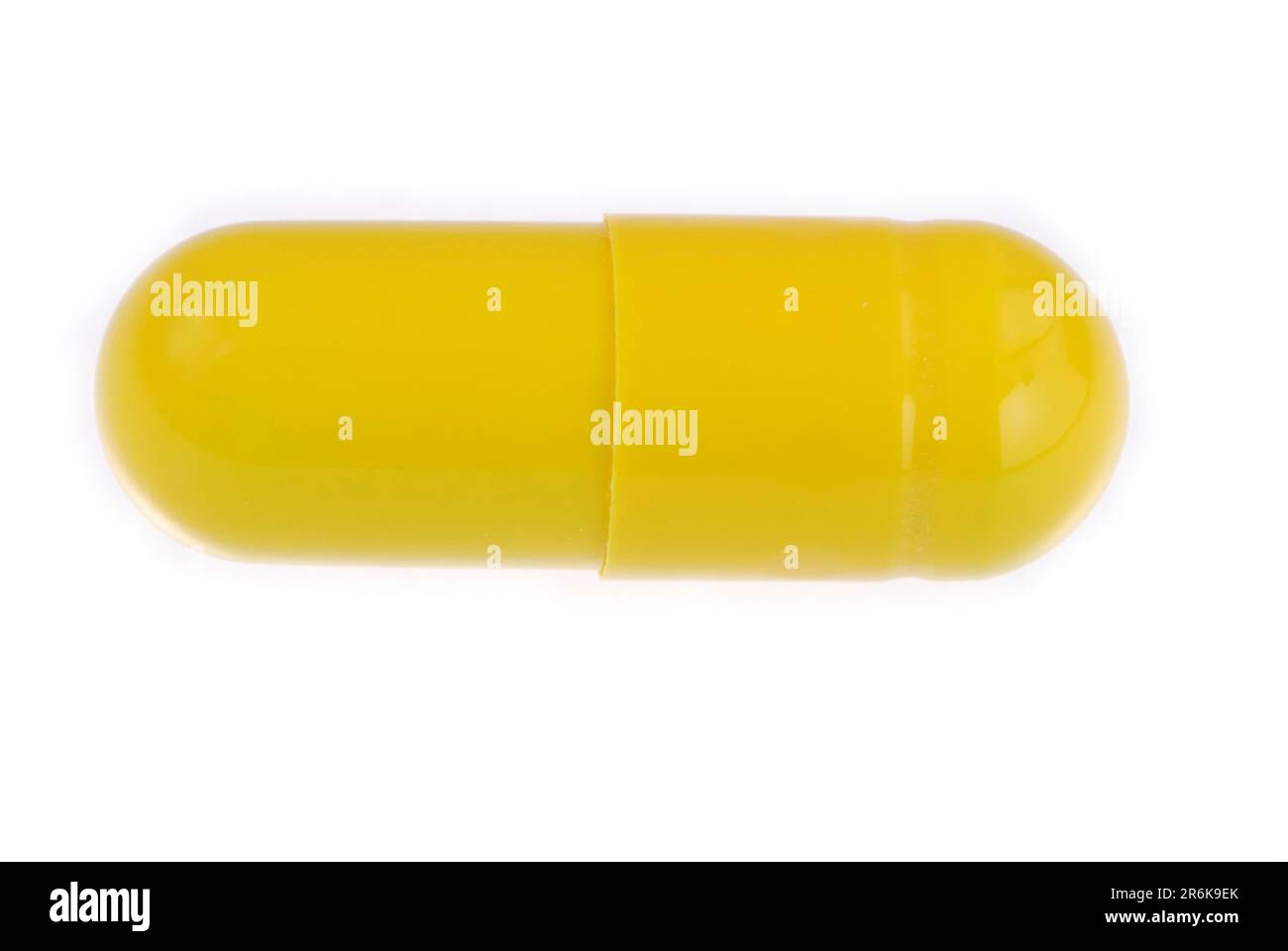 Macro of a yellow vitamine capsule Stock Photo - Alamy