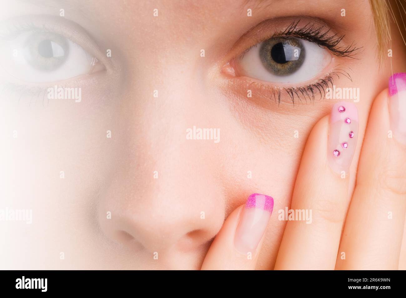 Female groomed fingernails in the face by the eye Stock Photo - Alamy