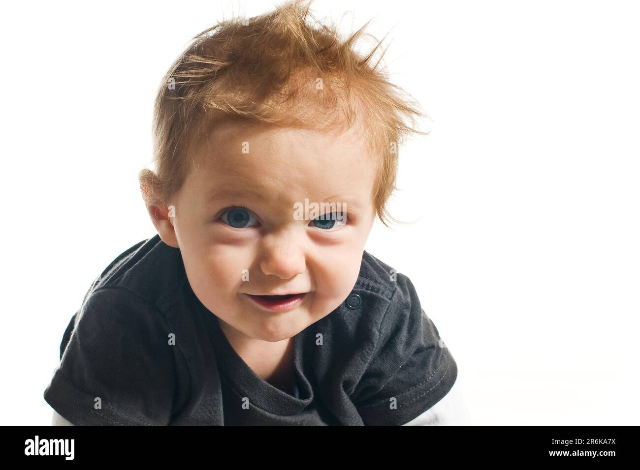 Baby with evil facial expression against white background Stock Photo ...