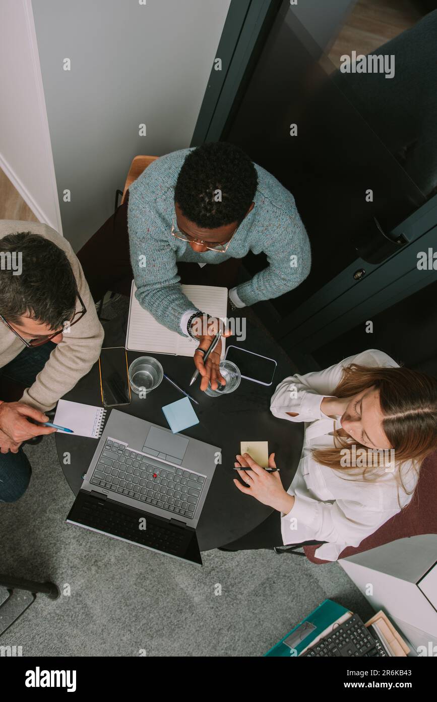 Inter-generational white coworkers listening to their black male ...