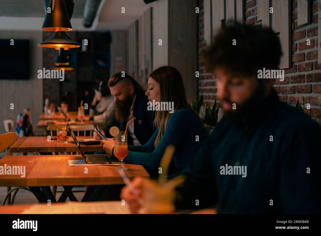 Two male and one female businesspeople working remotely at the coffee ...