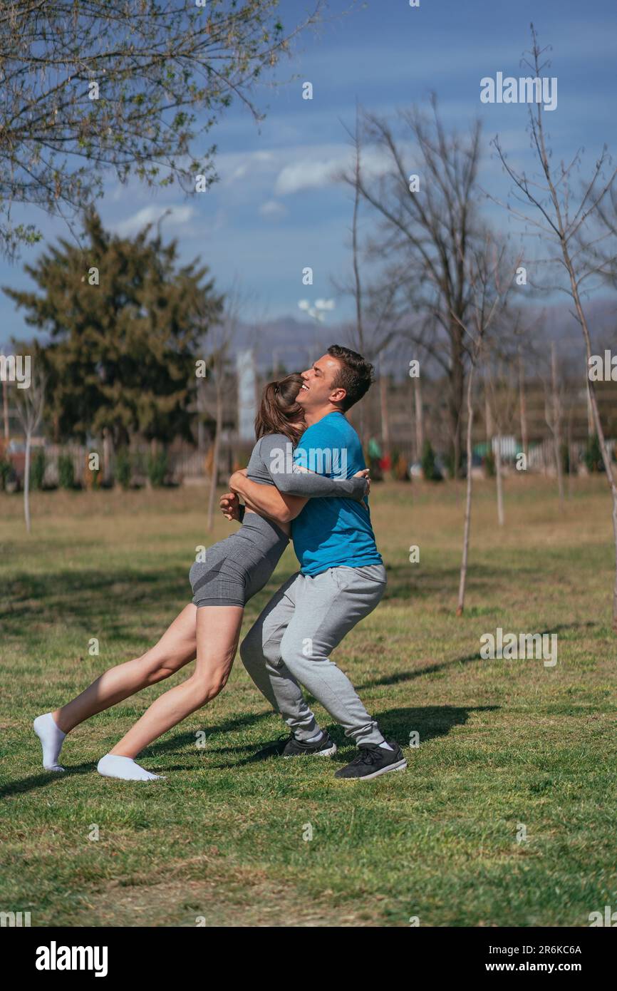 Fit male person saved his female partner from falling Stock Photo - Alamy