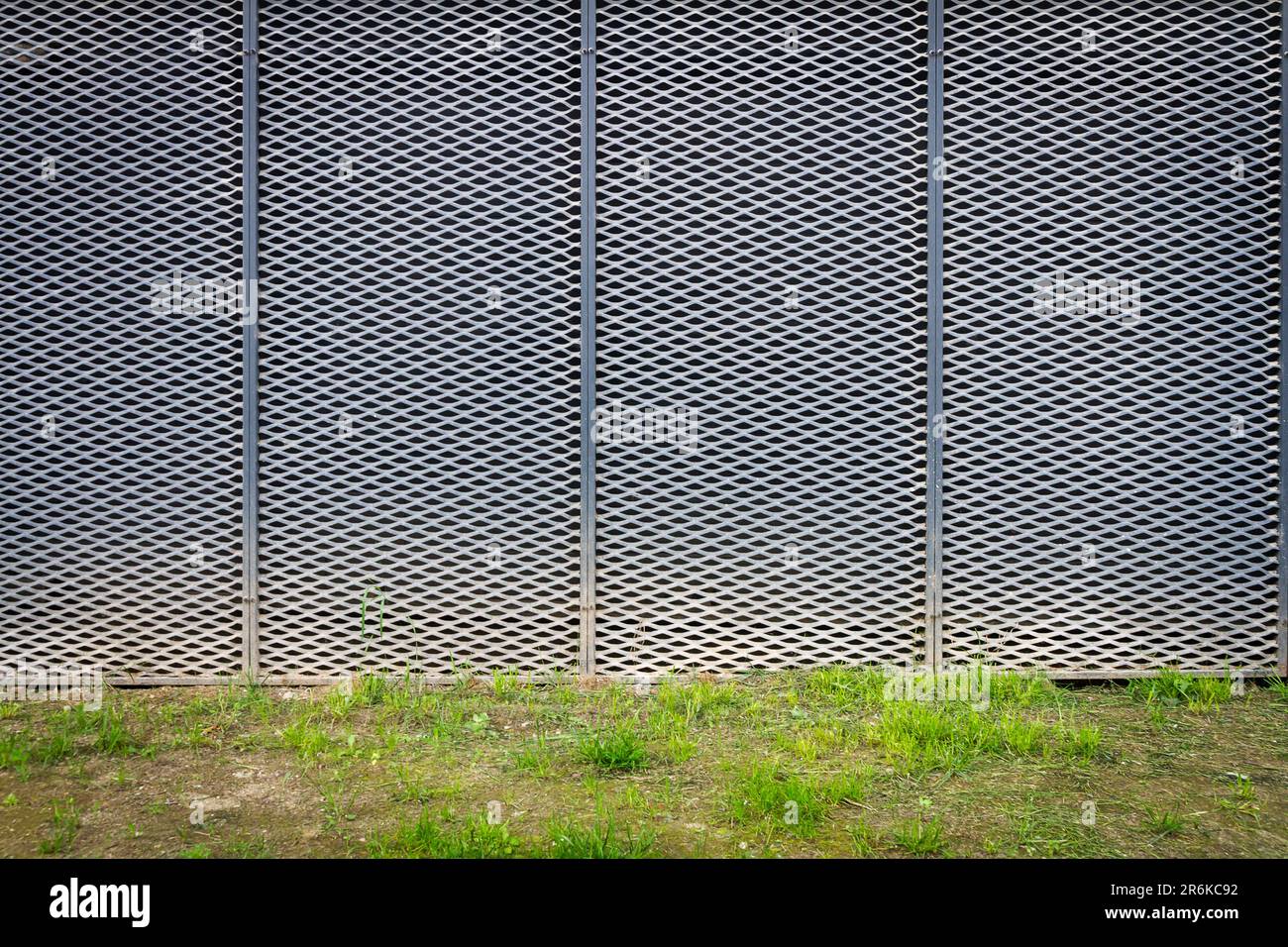 Iron grid wall and green grass. Architecture detail background Stock ...