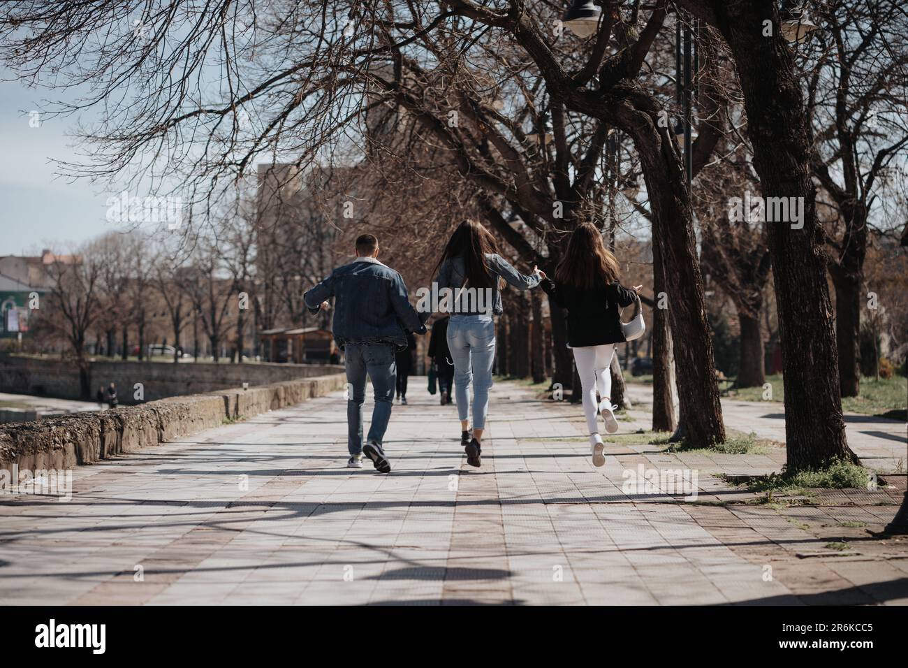 Three best friends having fun time while jumping and walking at the ...