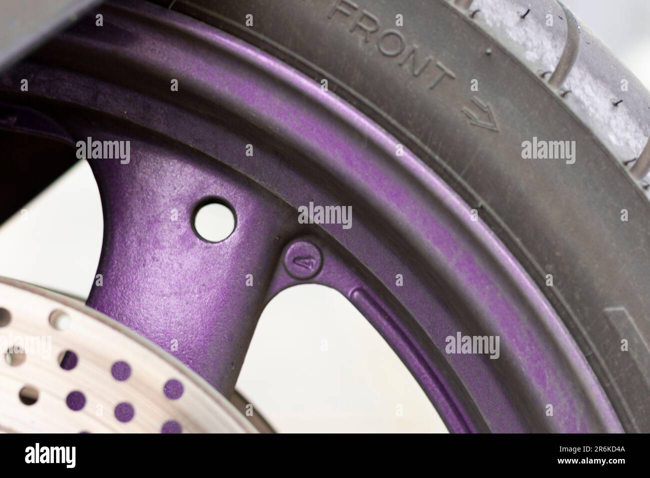 A Close-up of a motorcycle wheel featuring a unique rim design with ...