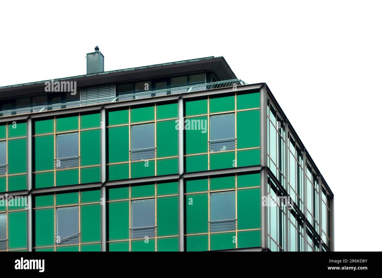 An office building featuring a modern green-tinted glass facade ...