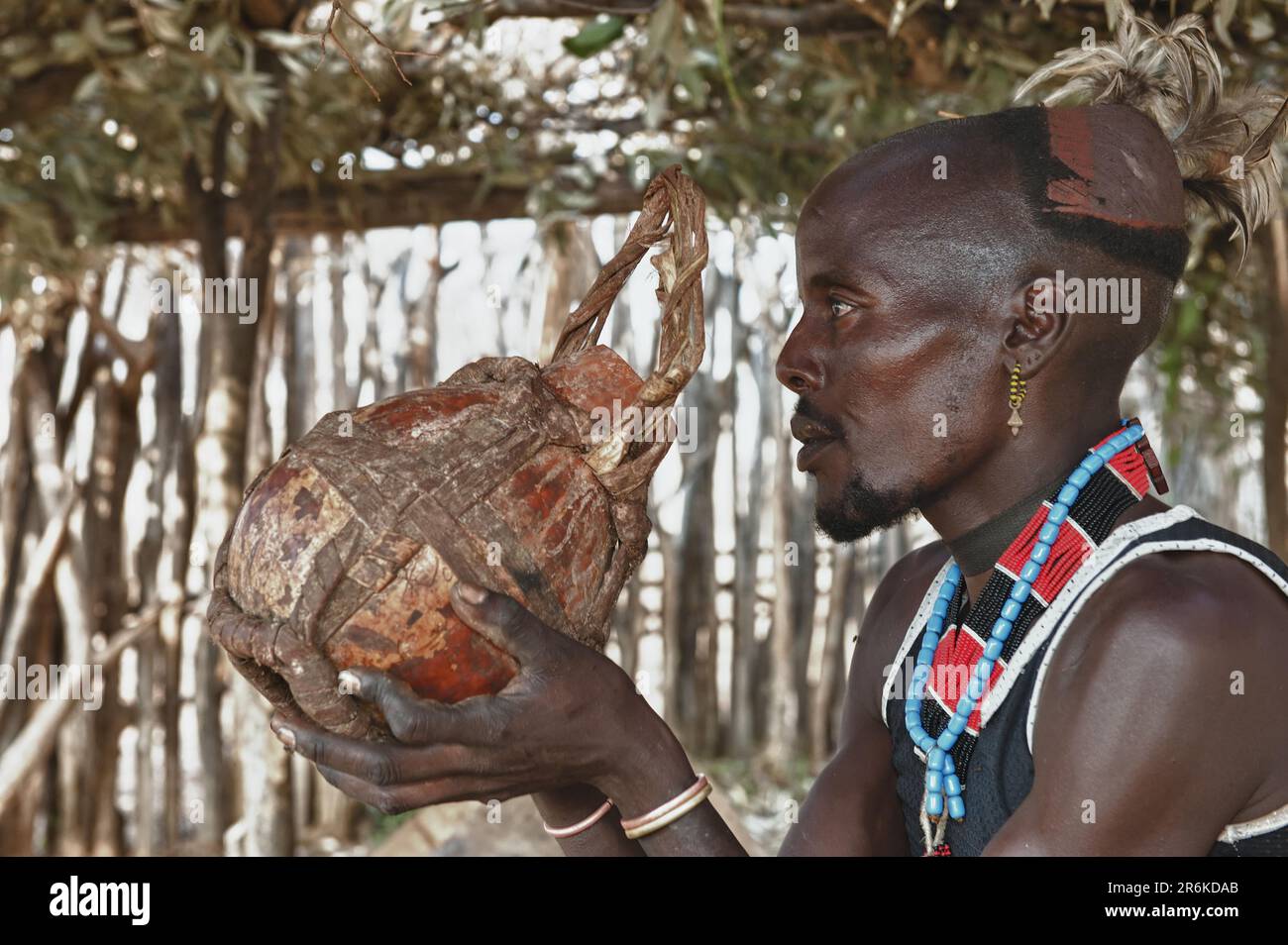 Hamar man drinks sorghum beer from bottle gourd, Omo Valley, Southern ...