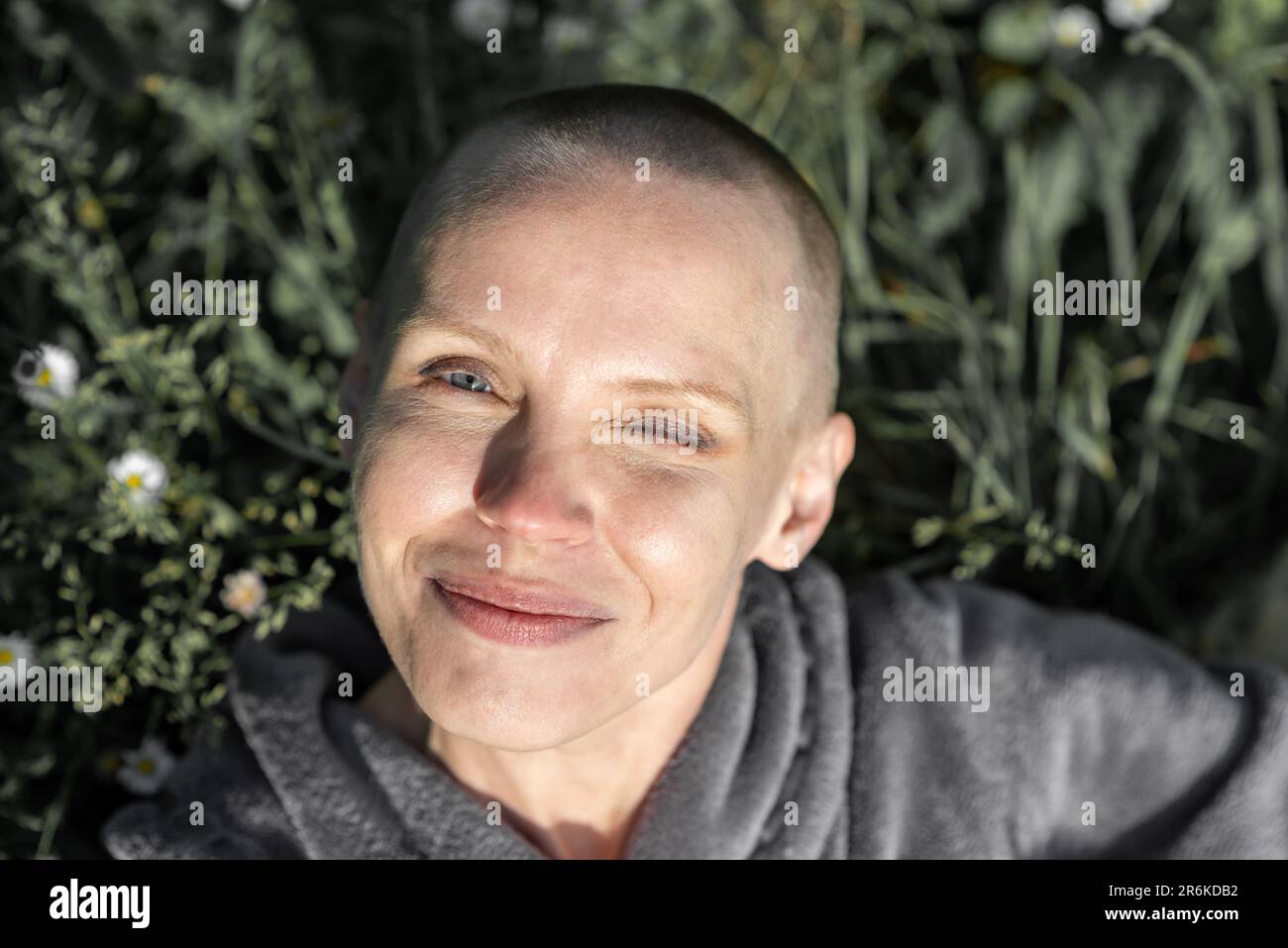 Portrait of a smiling bald woman on a background of grass Stock Photo ...