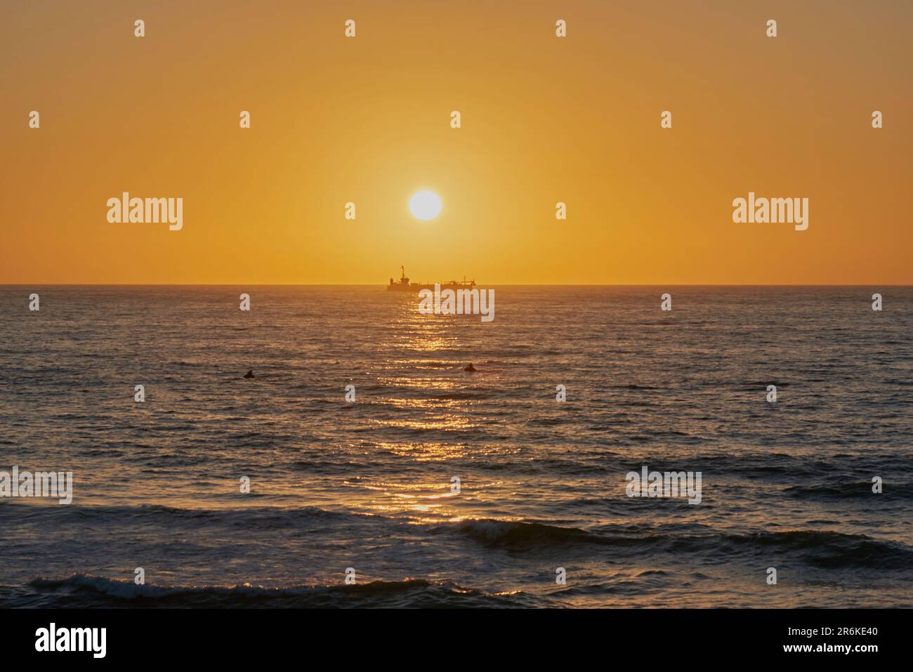 photo of a Boat captured at sunset facing the sun Stock Photo - Alamy