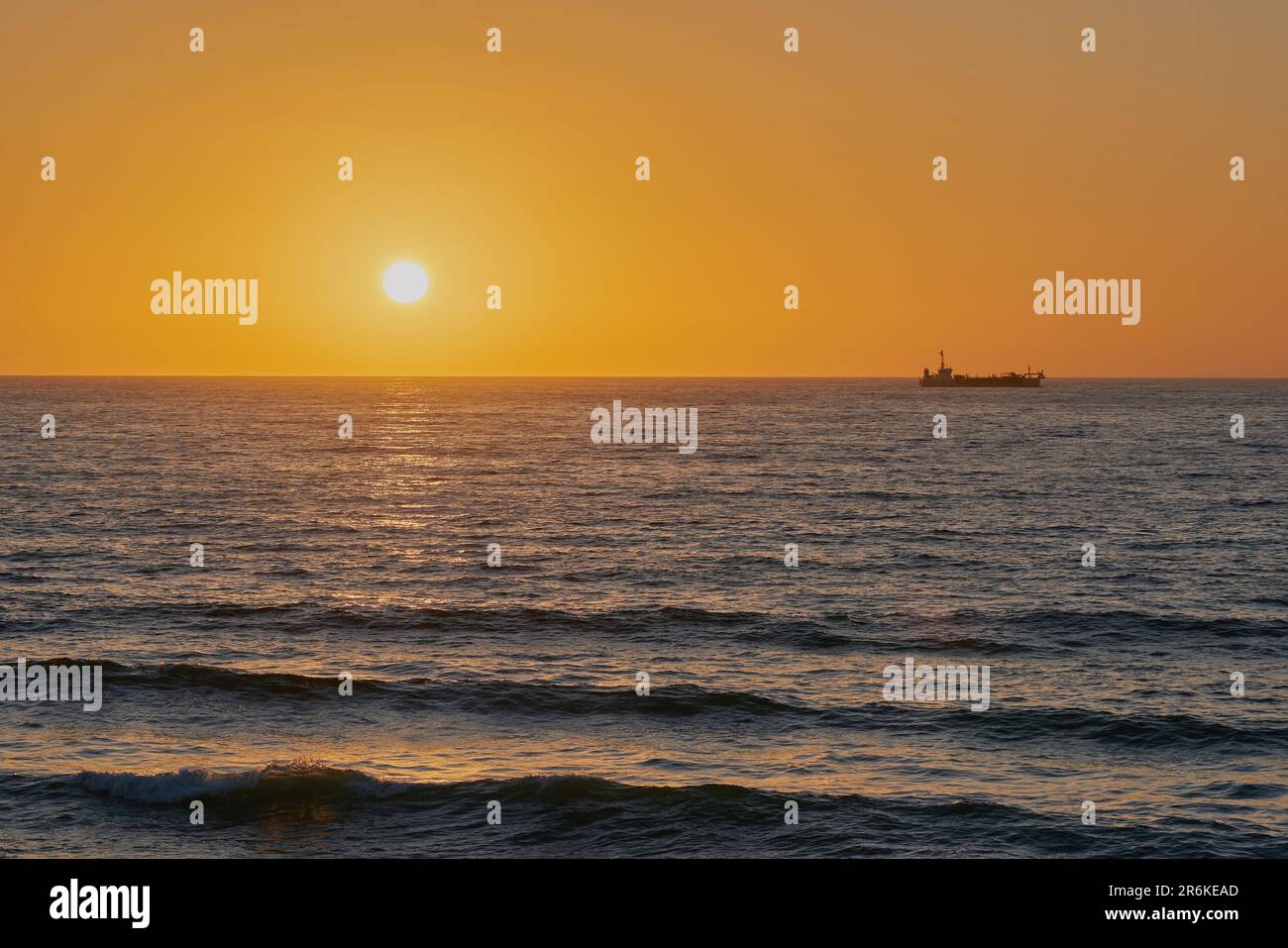 photo of a Boat captured at sunset facing the sun Stock Photo - Alamy