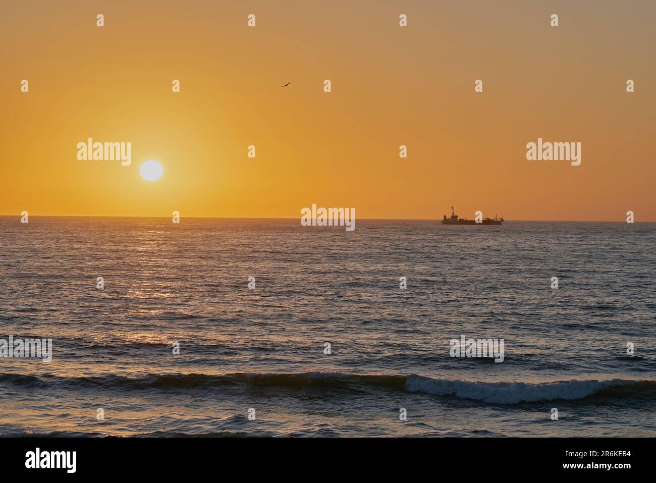 photo of a Boat captured at sunset facing the sun Stock Photo - Alamy