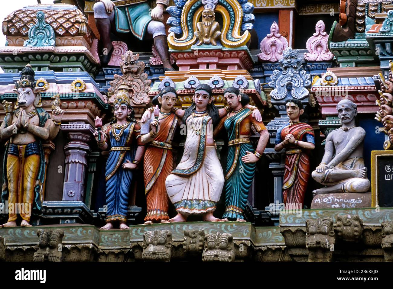 Stucco work portraying a woman about to deliver a baby in standing ...