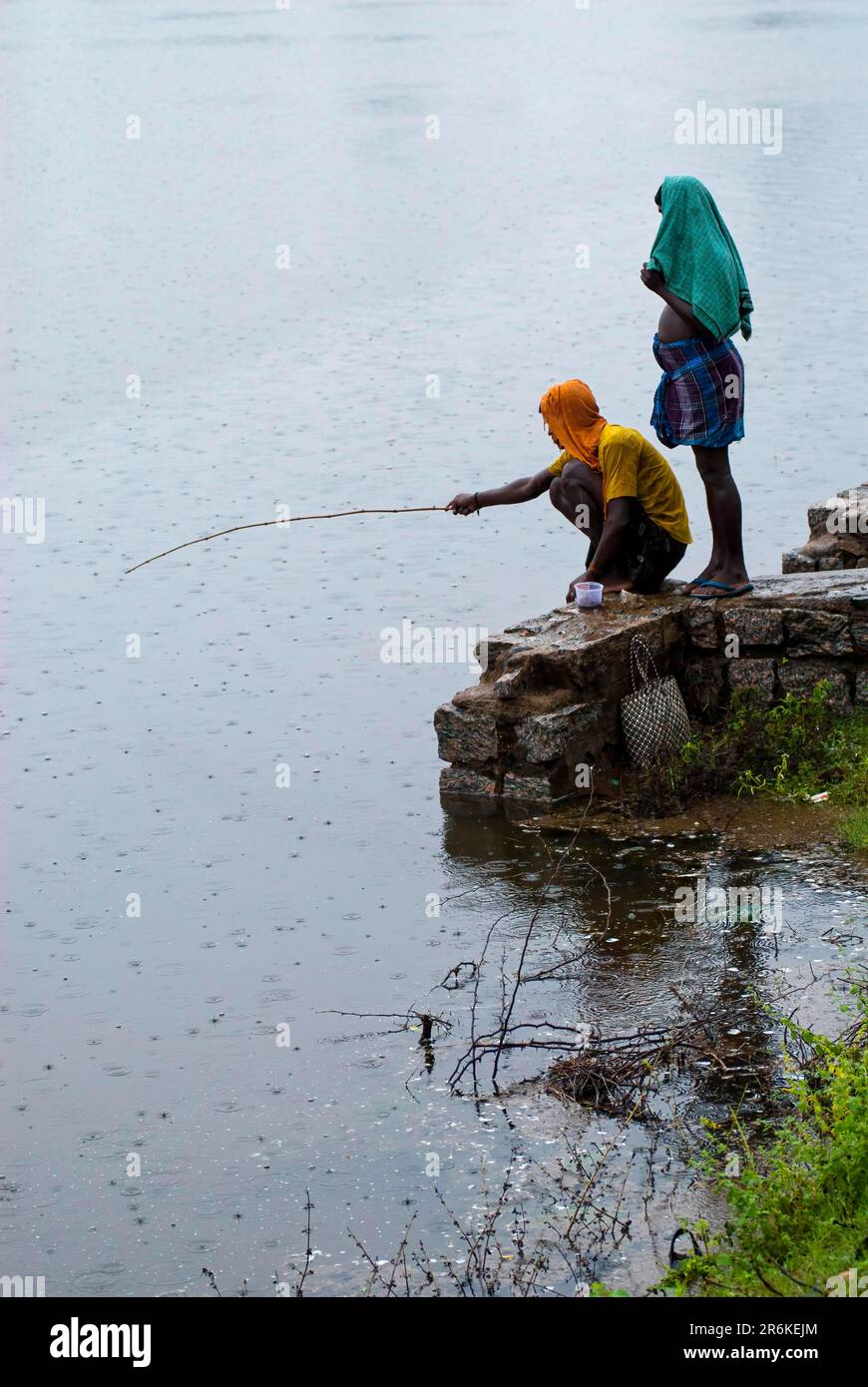 Village people angling during a rainy day, Tamil Nadu, South India ...