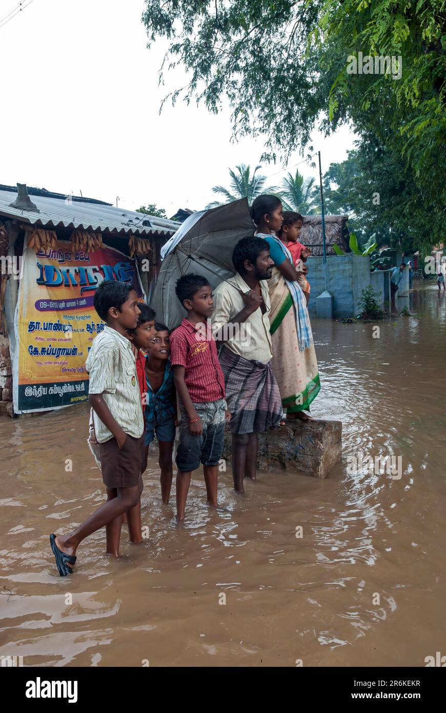 People standing on a culvert village logged on rain water, Tamil Nadu ...