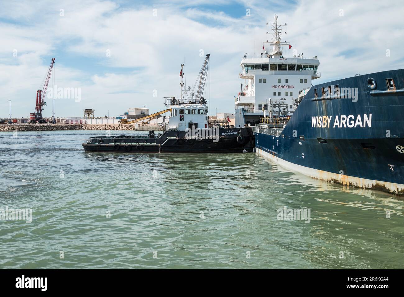 Maritime Coordination: Tugboat Engaged in Ship Towing at Laayoune Port ...