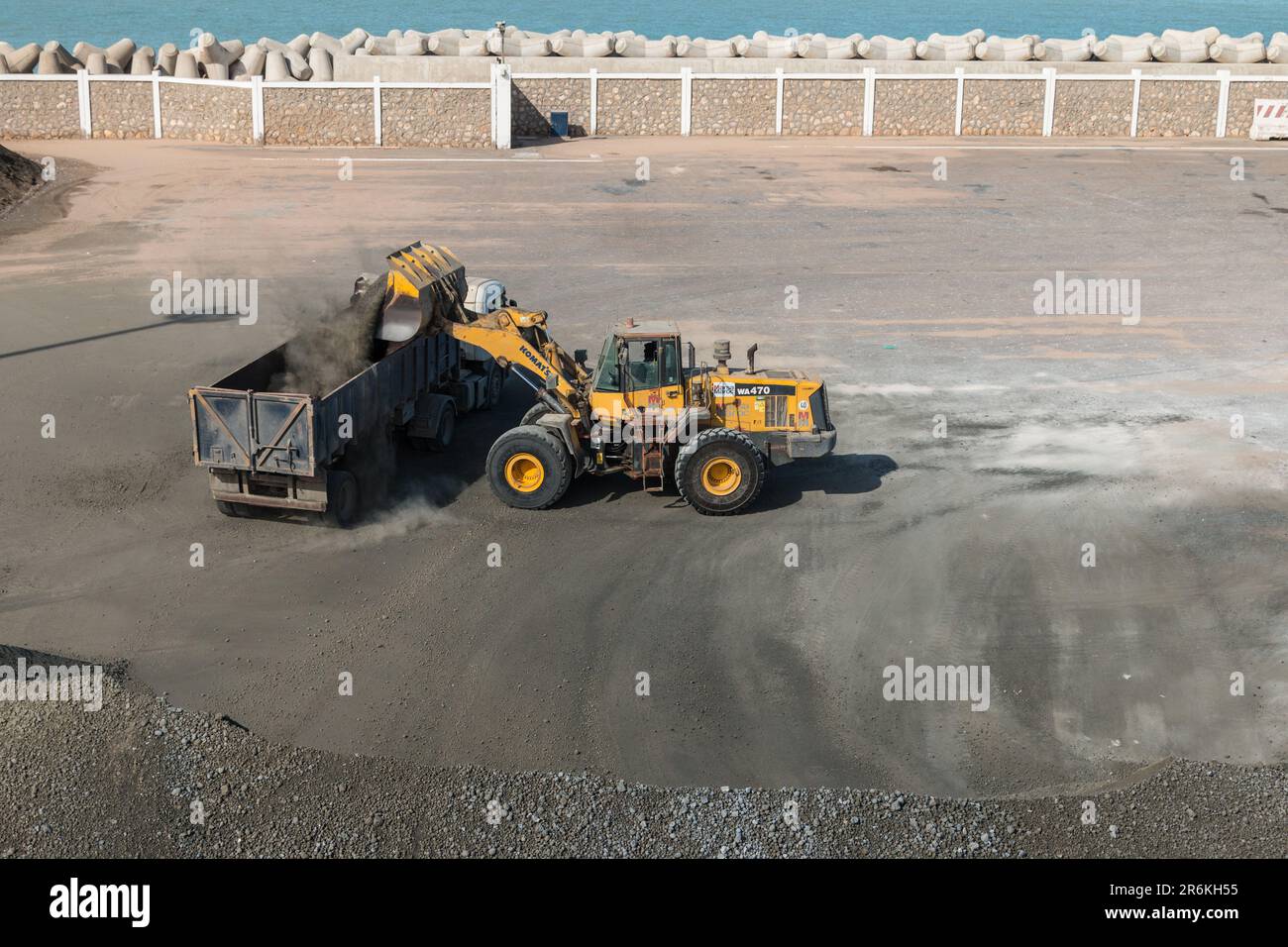 Excavator Loading Cement at Laayoune Port's Diverse and Bulk Quay Stock ...