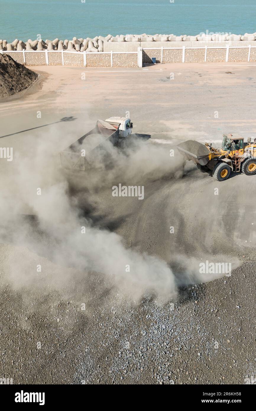 Excavator Loading Cement at Laayoune Port's Diverse and Bulk Quay Stock ...