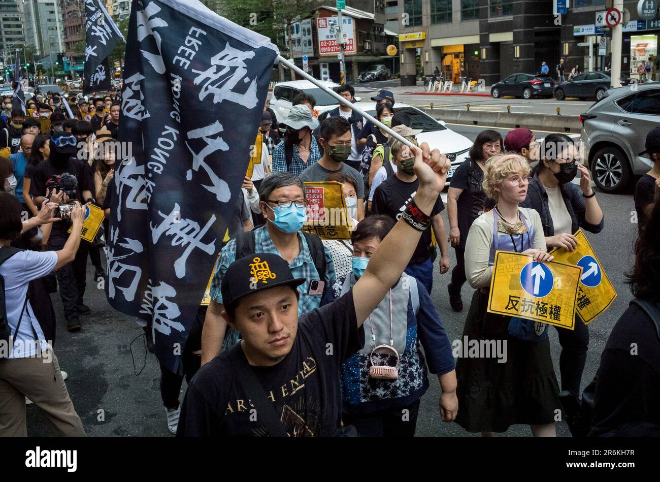 Protesters marching through the streets of Taipei, Taiwan on 10/06/2023 ...