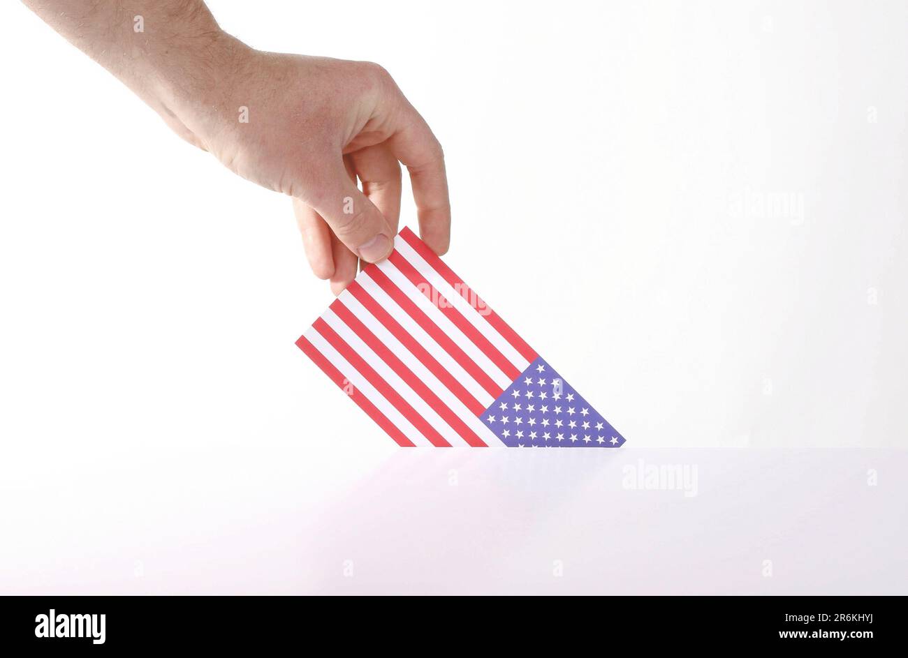 An American citizen placing a United States flag inside a ballot box ...