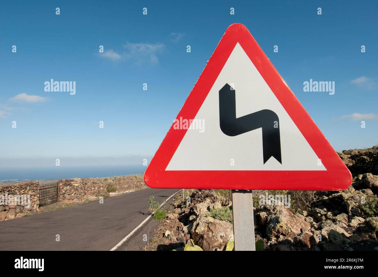 Bends in the road, triangular road sign Stock Photo - Alamy