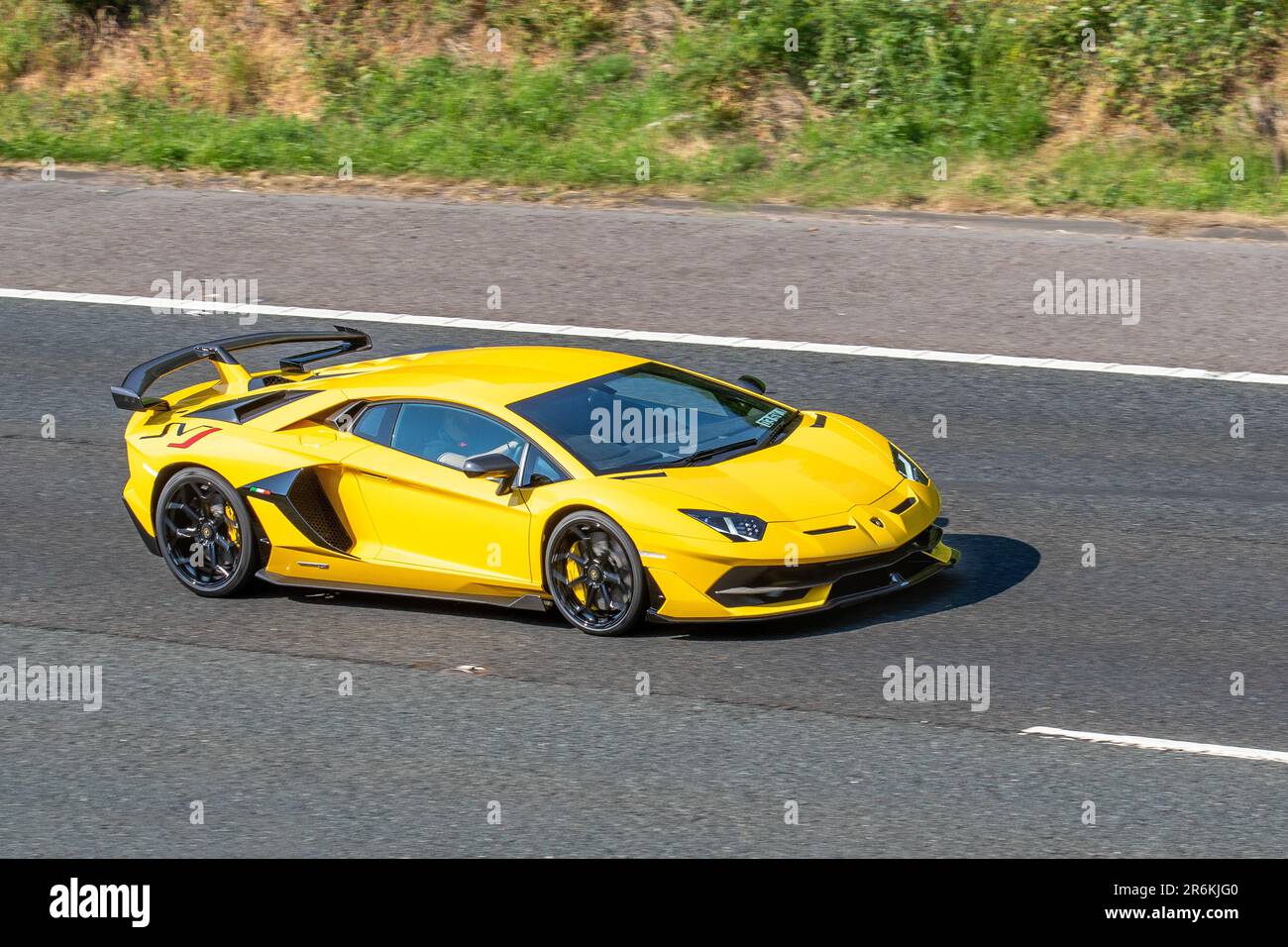 2016 yellow McLaren sports car; Vehicular traffic moving vehicles, cars ...